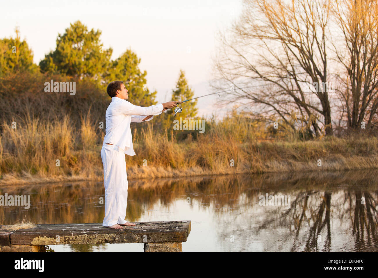 Young man fishing pier hi-res stock photography and images - Alamy