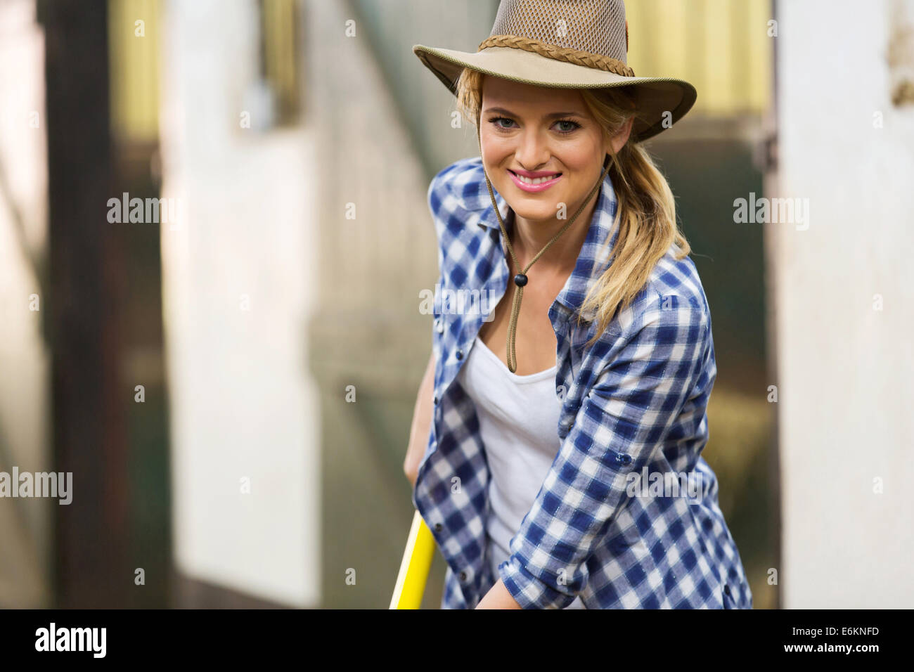 happy cowgirl working in stables Stock Photo - Alamy
