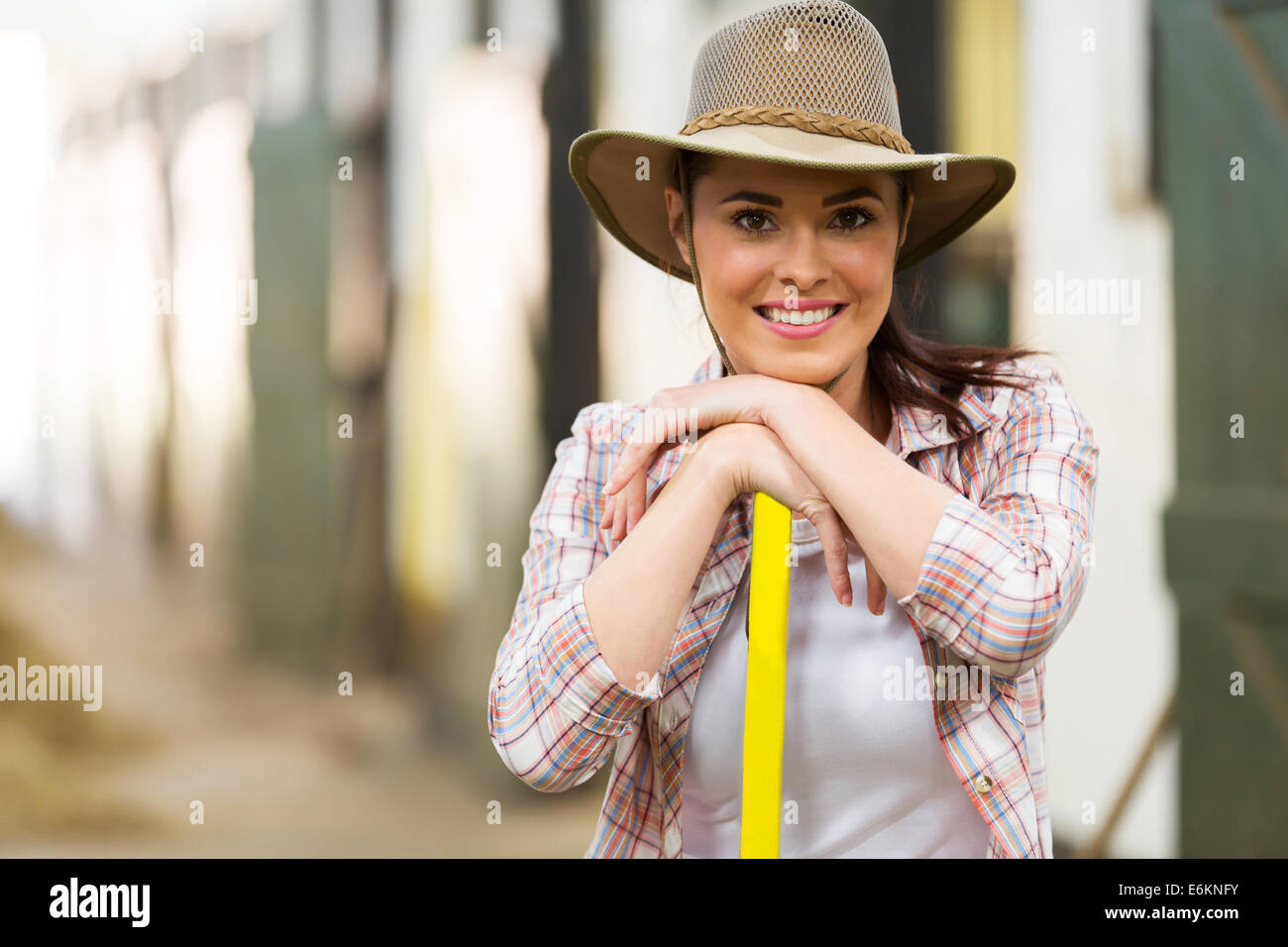 pretty female horse farm worker inside stables Stock Photo - Alamy