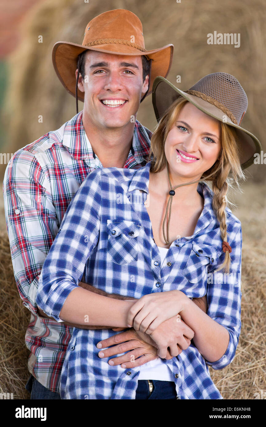 young farming couple hugging inside barn Stock Photo - Alamy