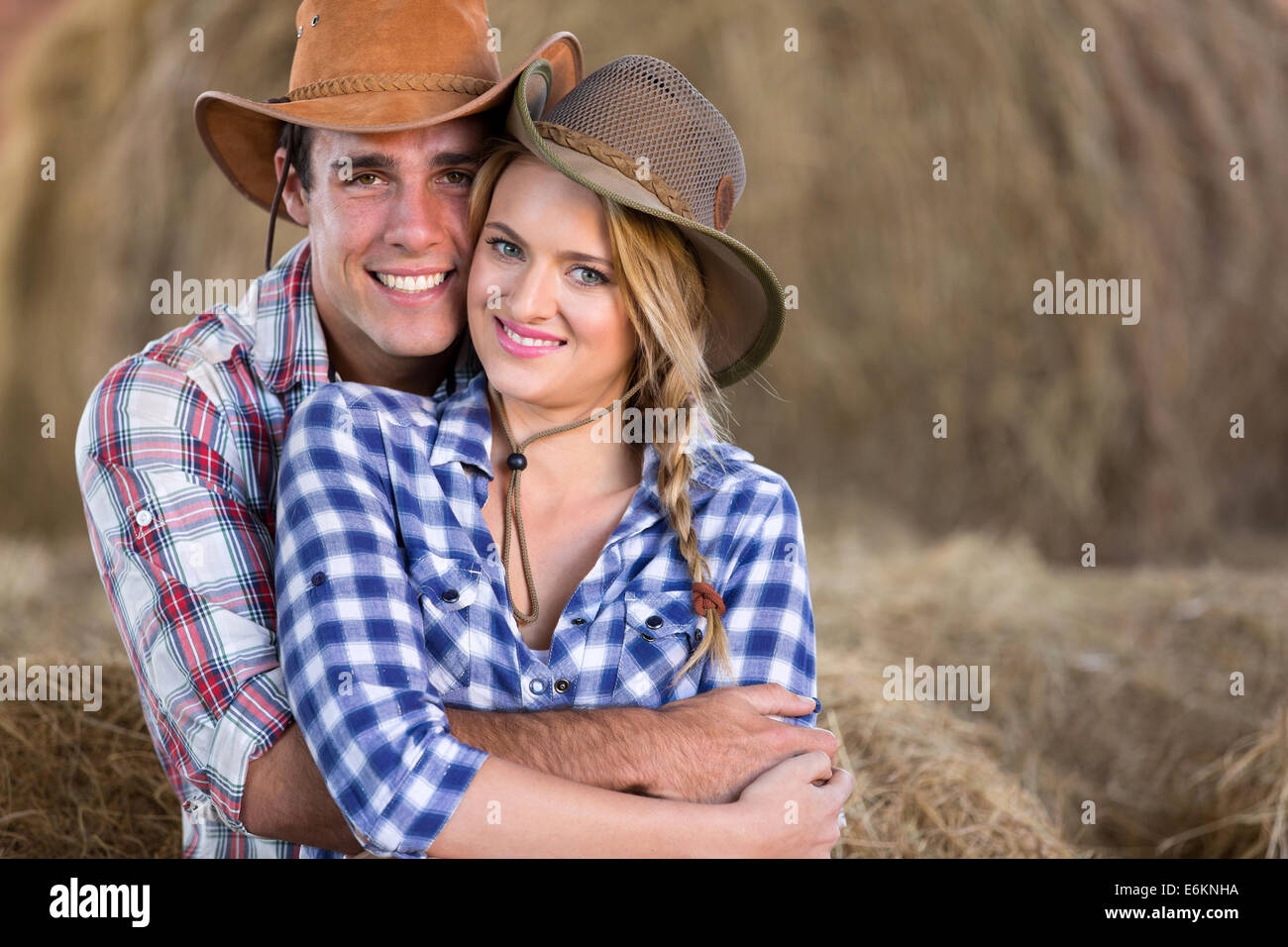 portrait of young cute farming couple hugging in barn Stock Photo - Alamy