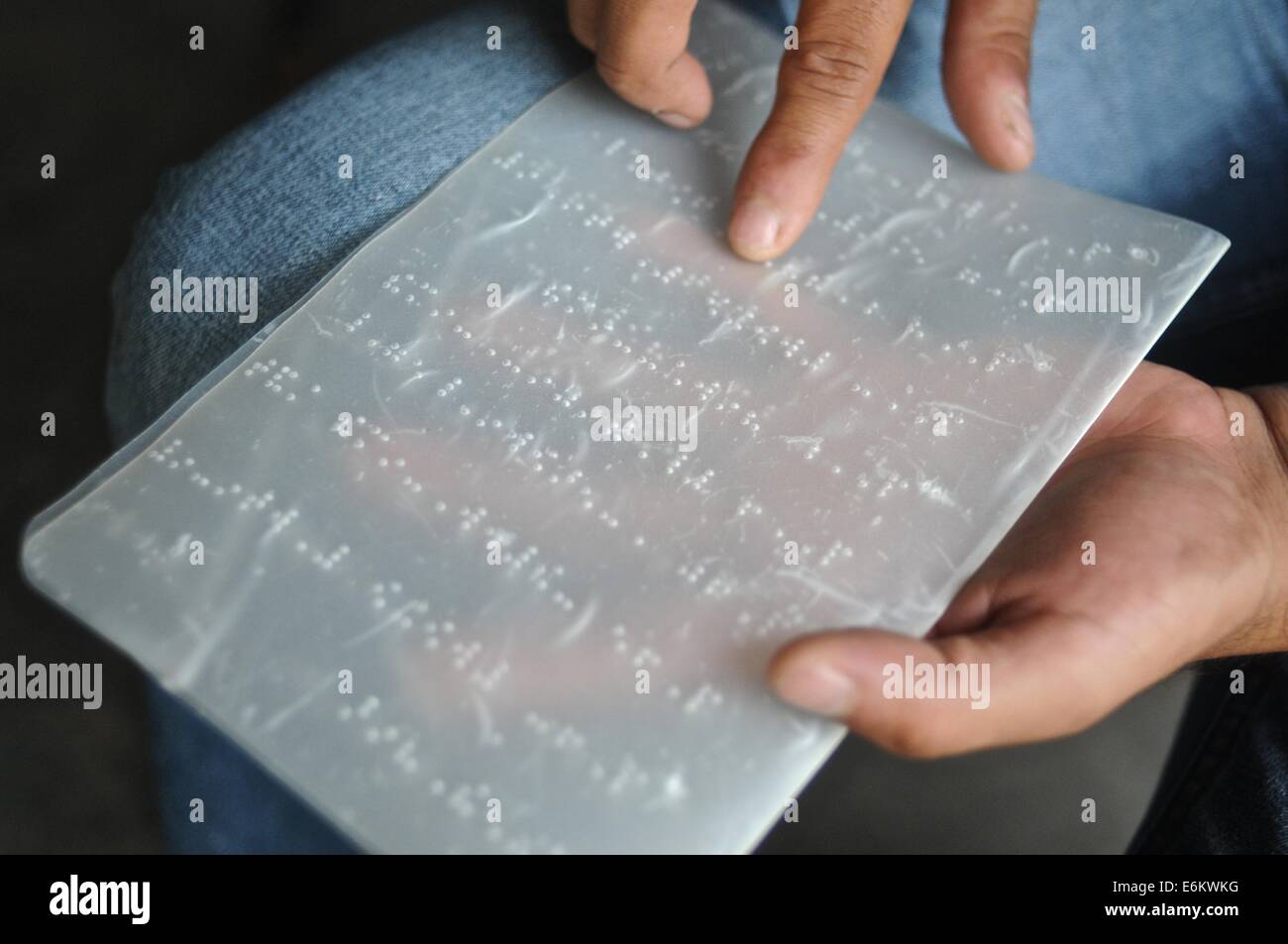 Blind man reading from a page written in braille Stock Photo - Alamy