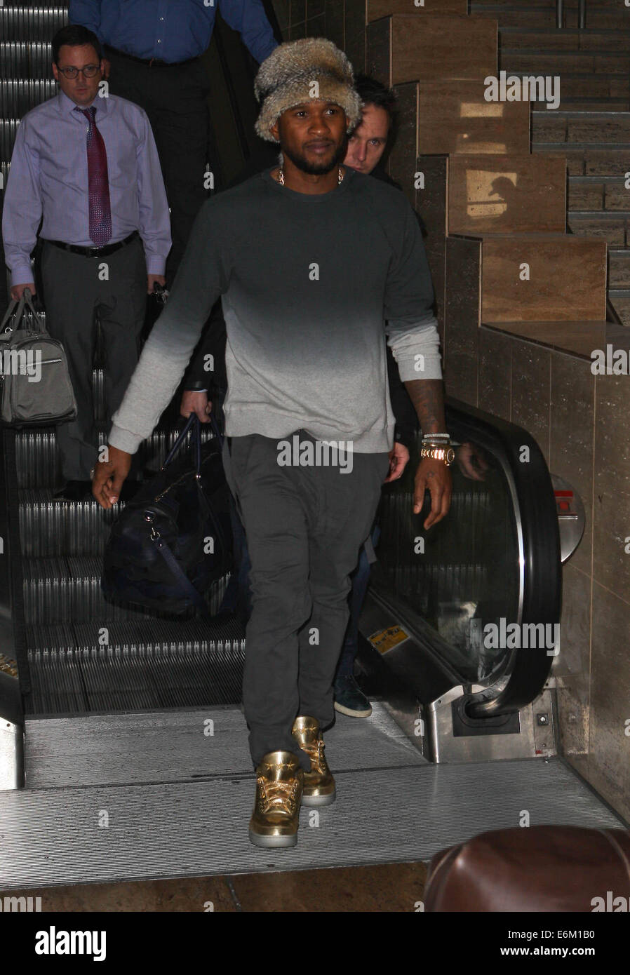 Usher arrives at Los Angeles International Airport (LAX) wearing gold ...