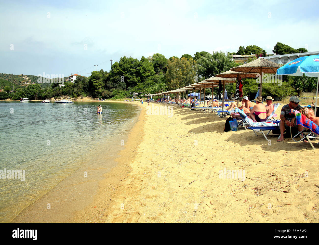 Holidaymakers enjoying the sun, sea and sand on Kolios beach on the ... Holidaymakers enjoying the sun, sea and sand on Kolios beach on the ...