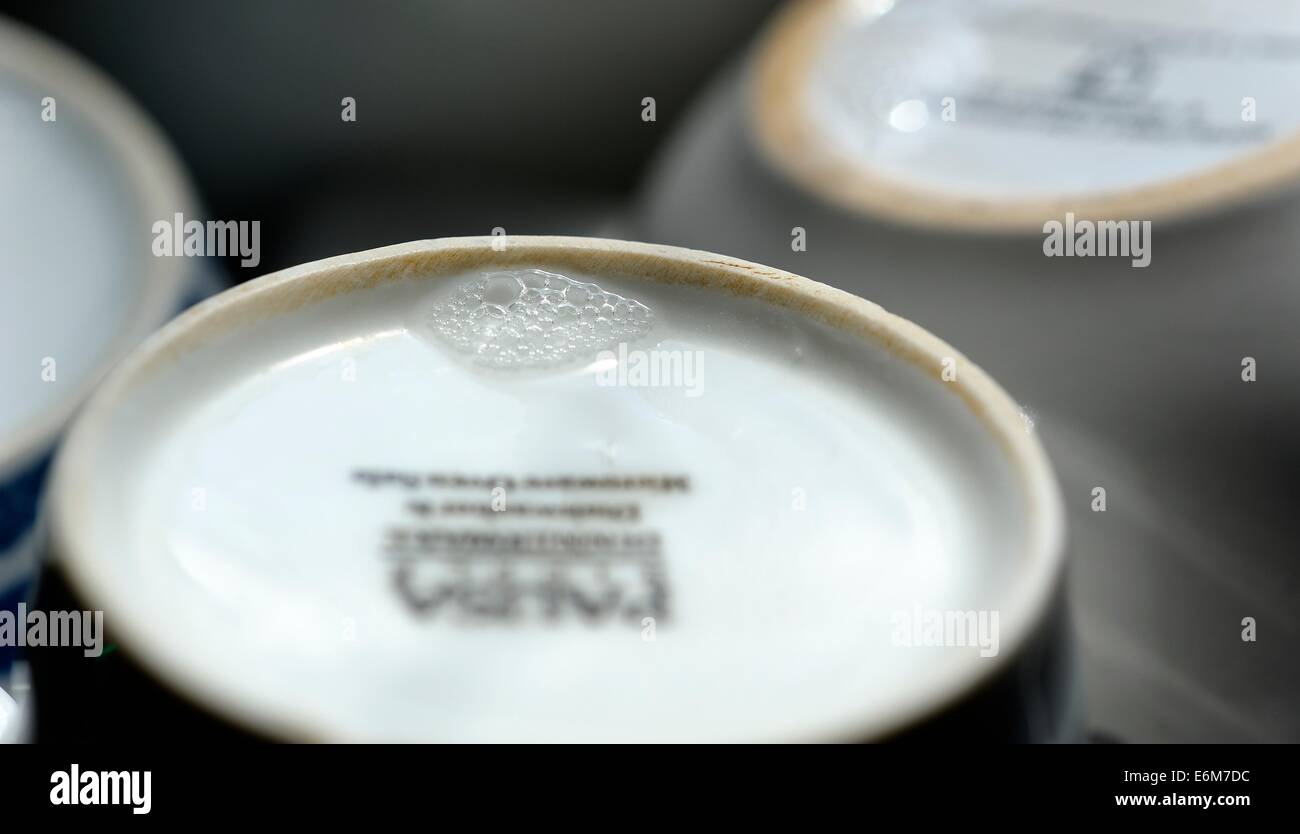 upside down mugs drying after being washed up in a kitchen sink Stock ...