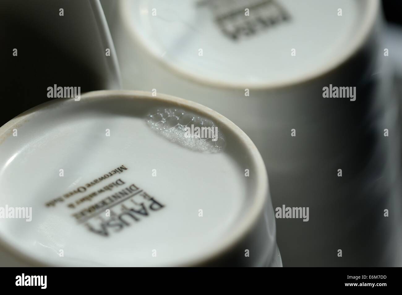 upside down mugs drying after being washed up in a kitchen sink Stock ...