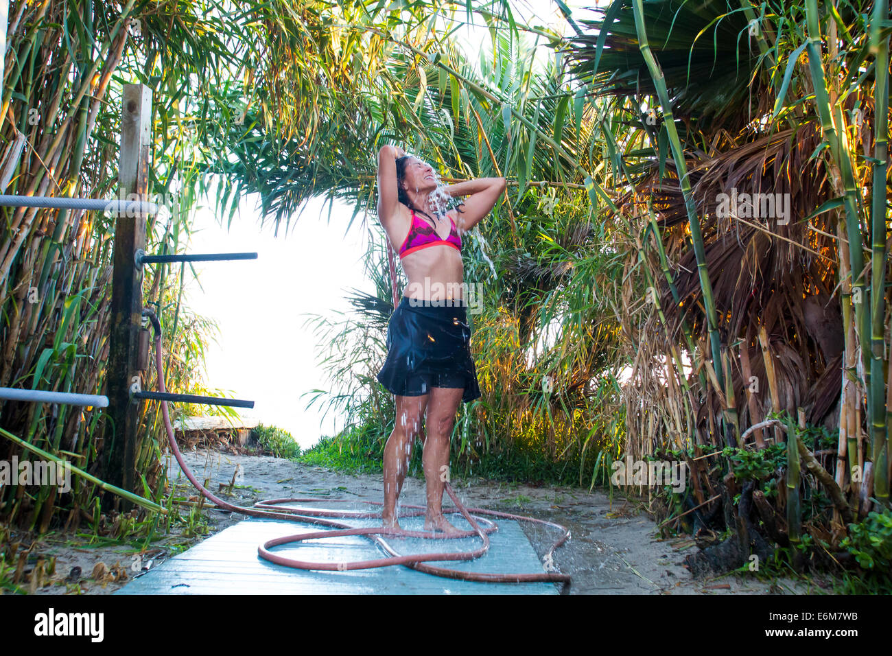 Woman taking shower after swimming Stock Photo - Alamy
