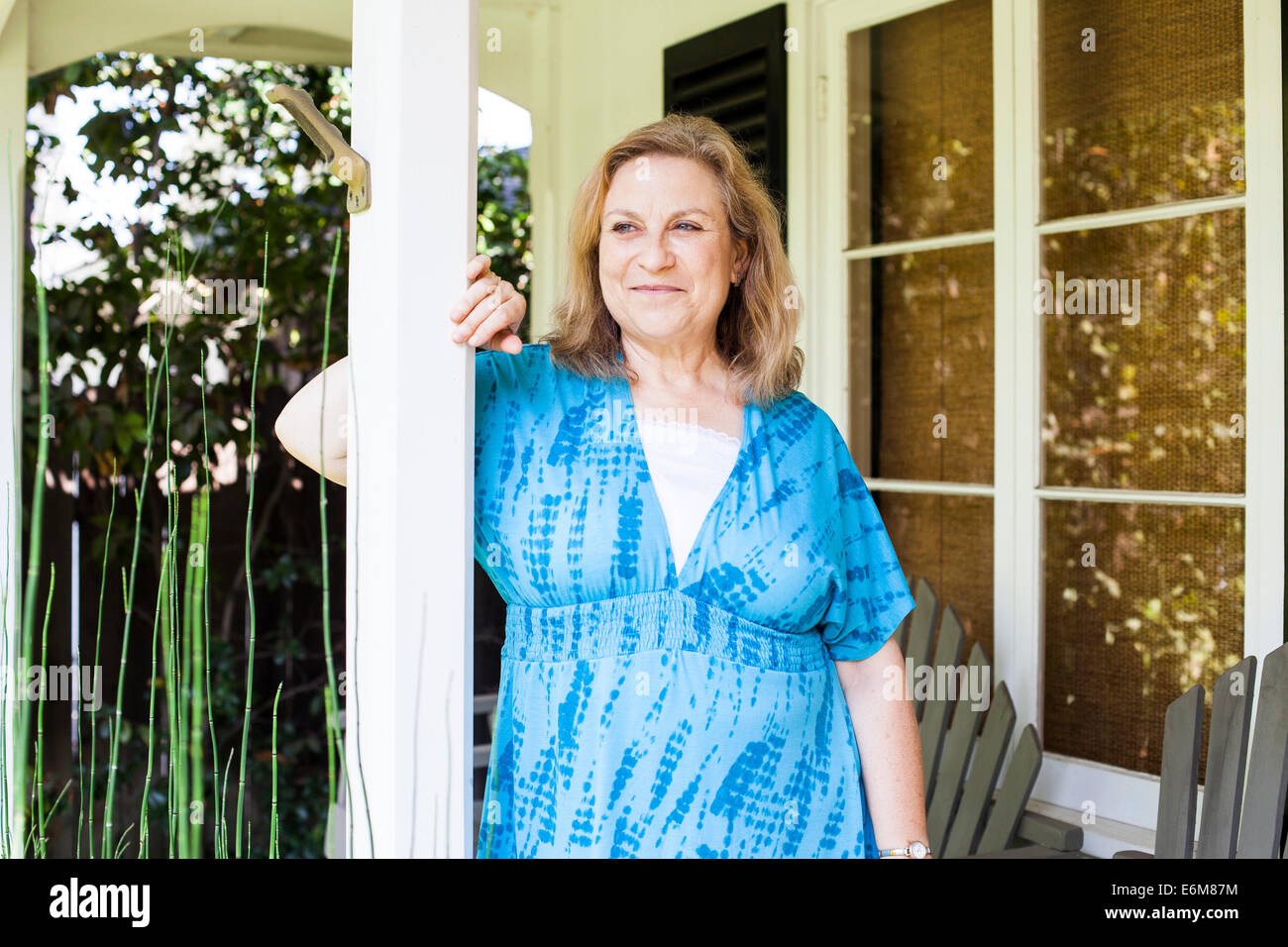 Woman standing outside house hi-res stock photography and images - Alamy