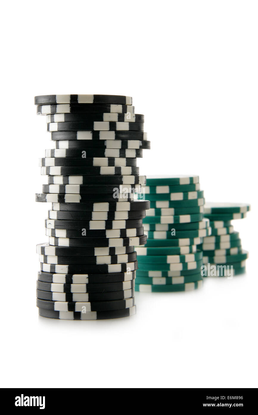 Three stacks of casino chips isolated over a white background. Focus on ...