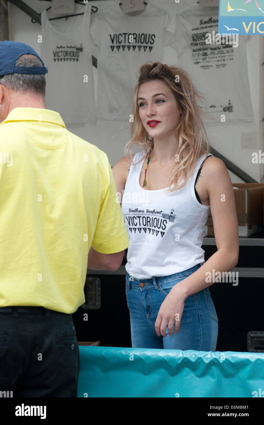 young female smiles after serving a customer at the victorious festival ...