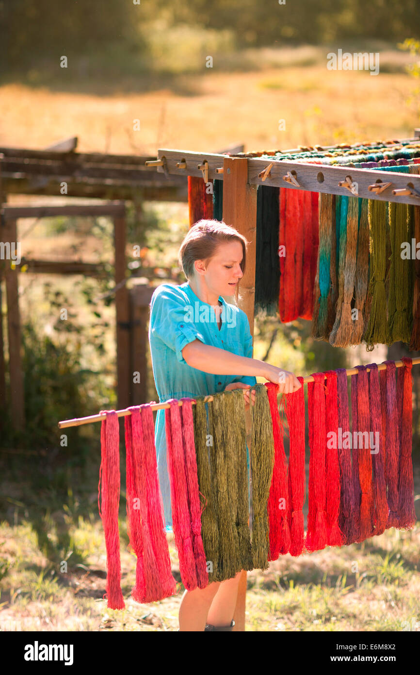Woman hanging yarn for drying Stock Photo - Alamy