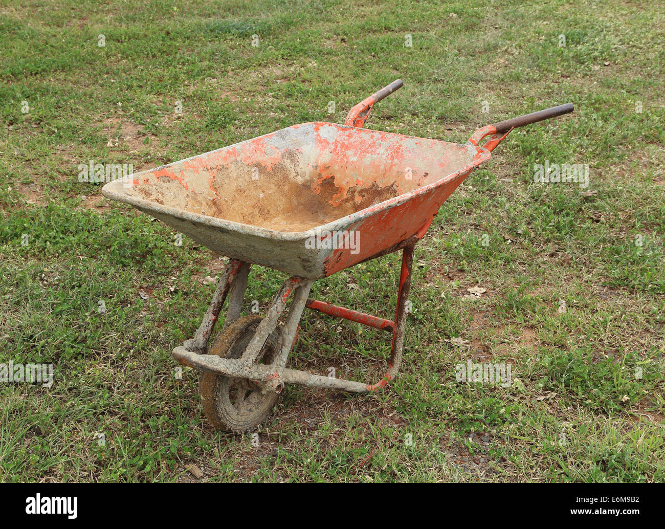 Old wheelbarrow on grass field Stock Photo - Alamy