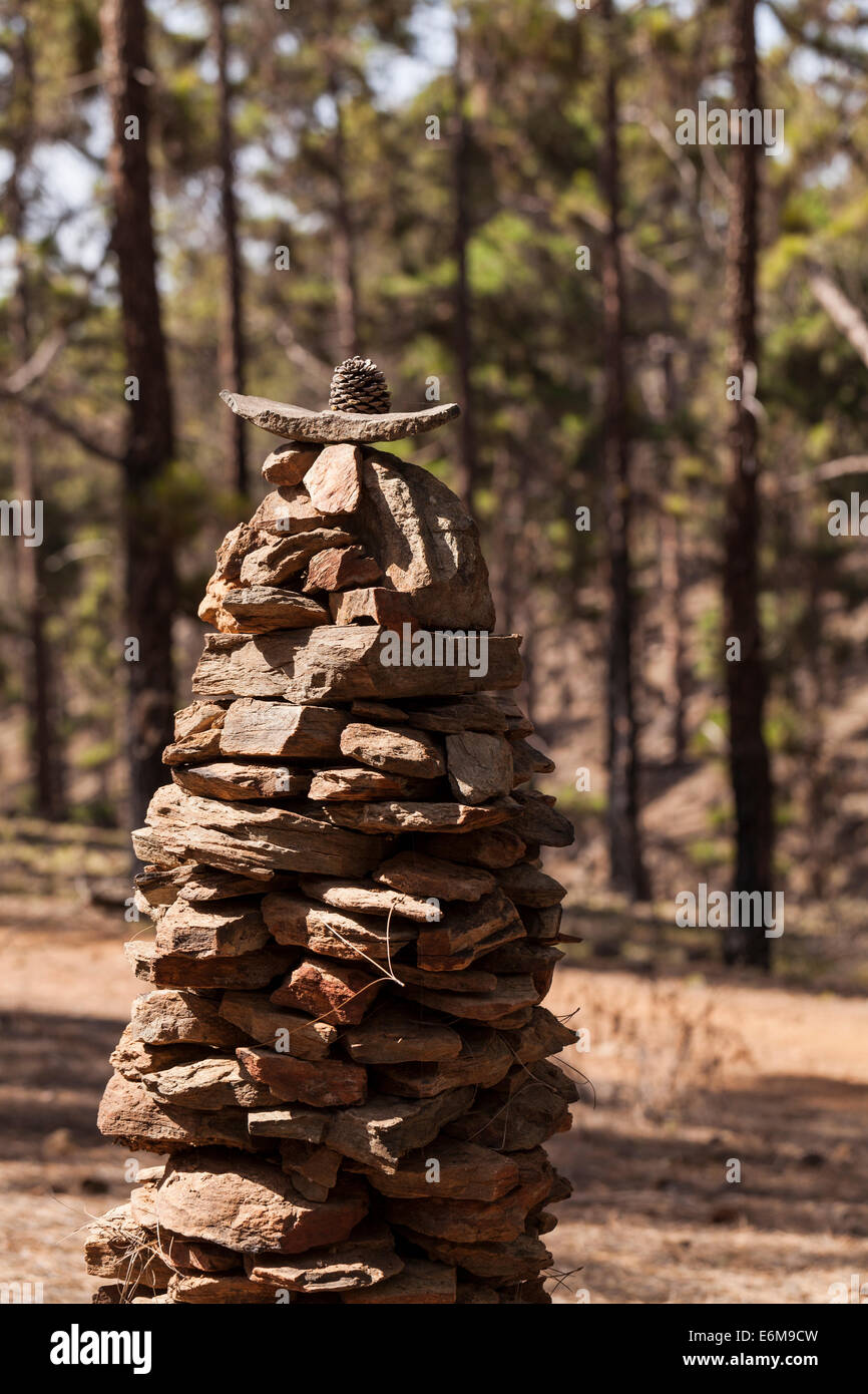 Stone cairns built by walkers to mark the way on a forest path near ...