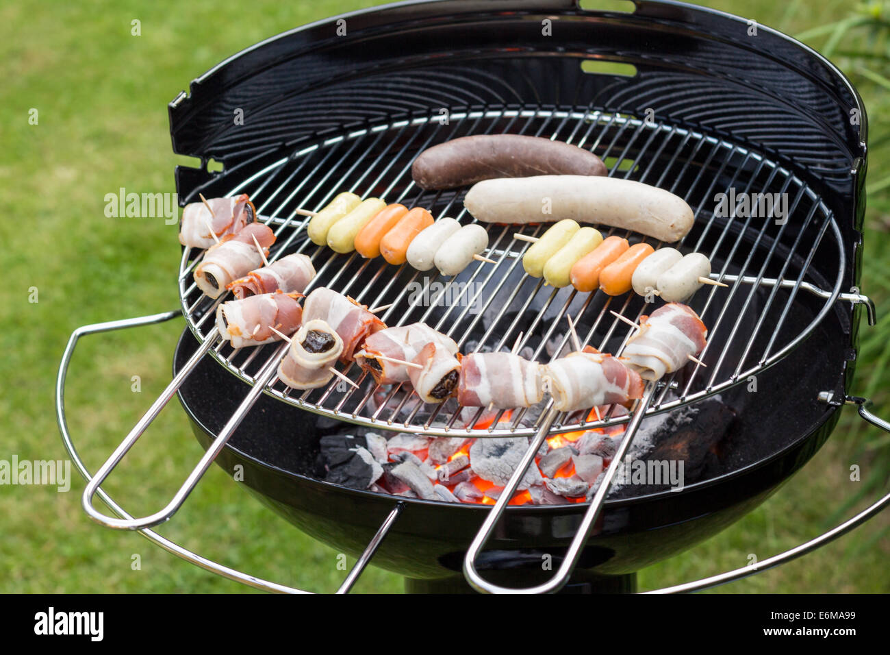 Barbecue grill filled with raw meat assortment Stock Photo - Alamy