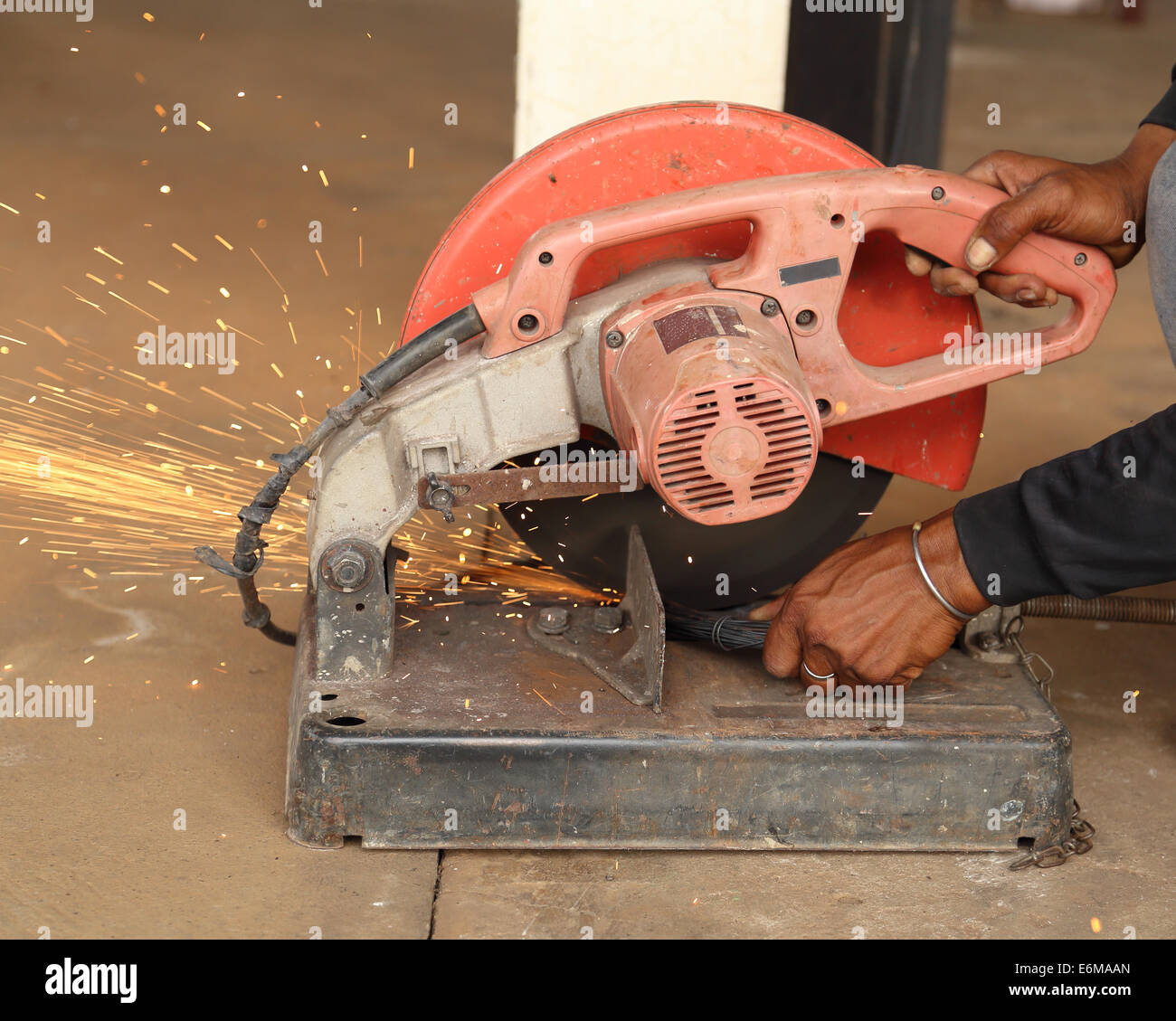 Worker cutting metal with cutting machine Stock Photo - Alamy