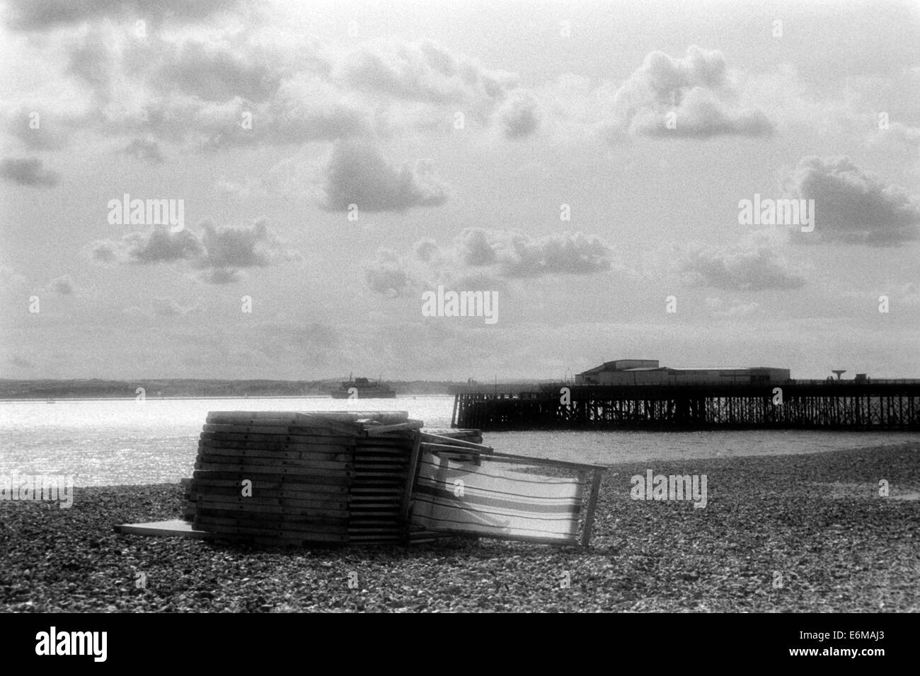 deck chairs on the beach along with south parade pier black and white ...