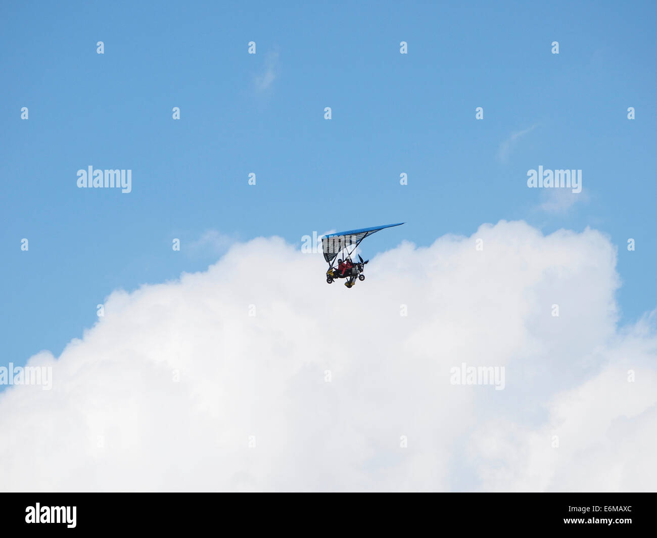 Ultralight aeroplane in blue sky with clouds, Jura, France Stock Photo ...