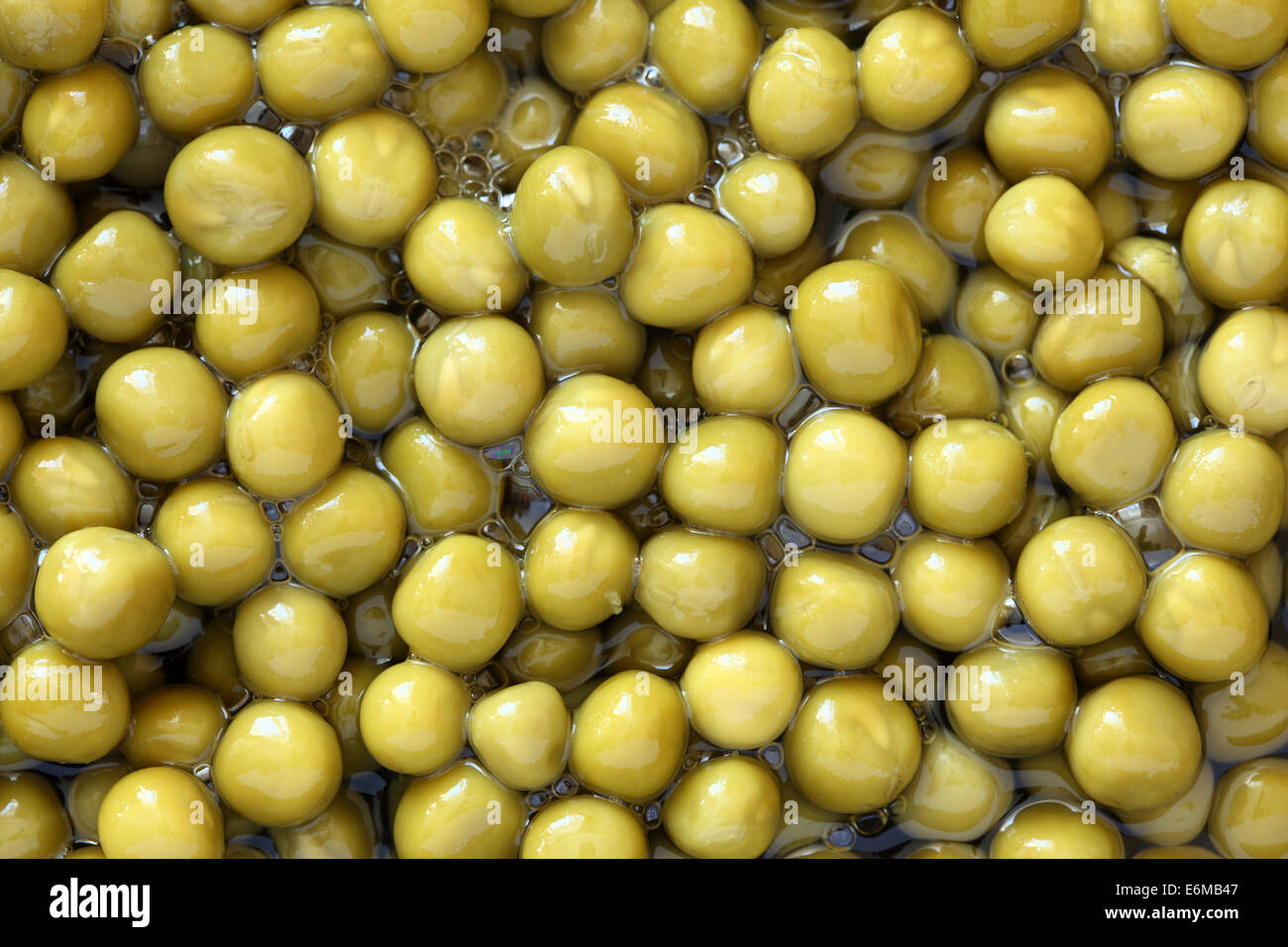 Preserved green peas background Stock Photo - Alamy