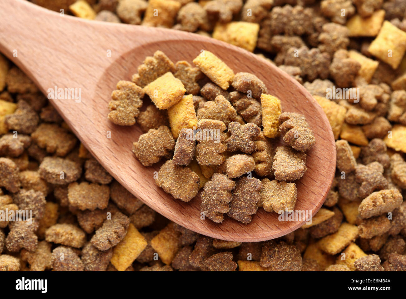 Cat food in a wooden spoon on cat food background Stock Photo - Alamy