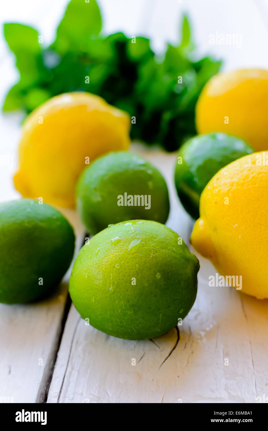 Citrus fresh fruits - lemon and lime on the white wooden table Stock ...