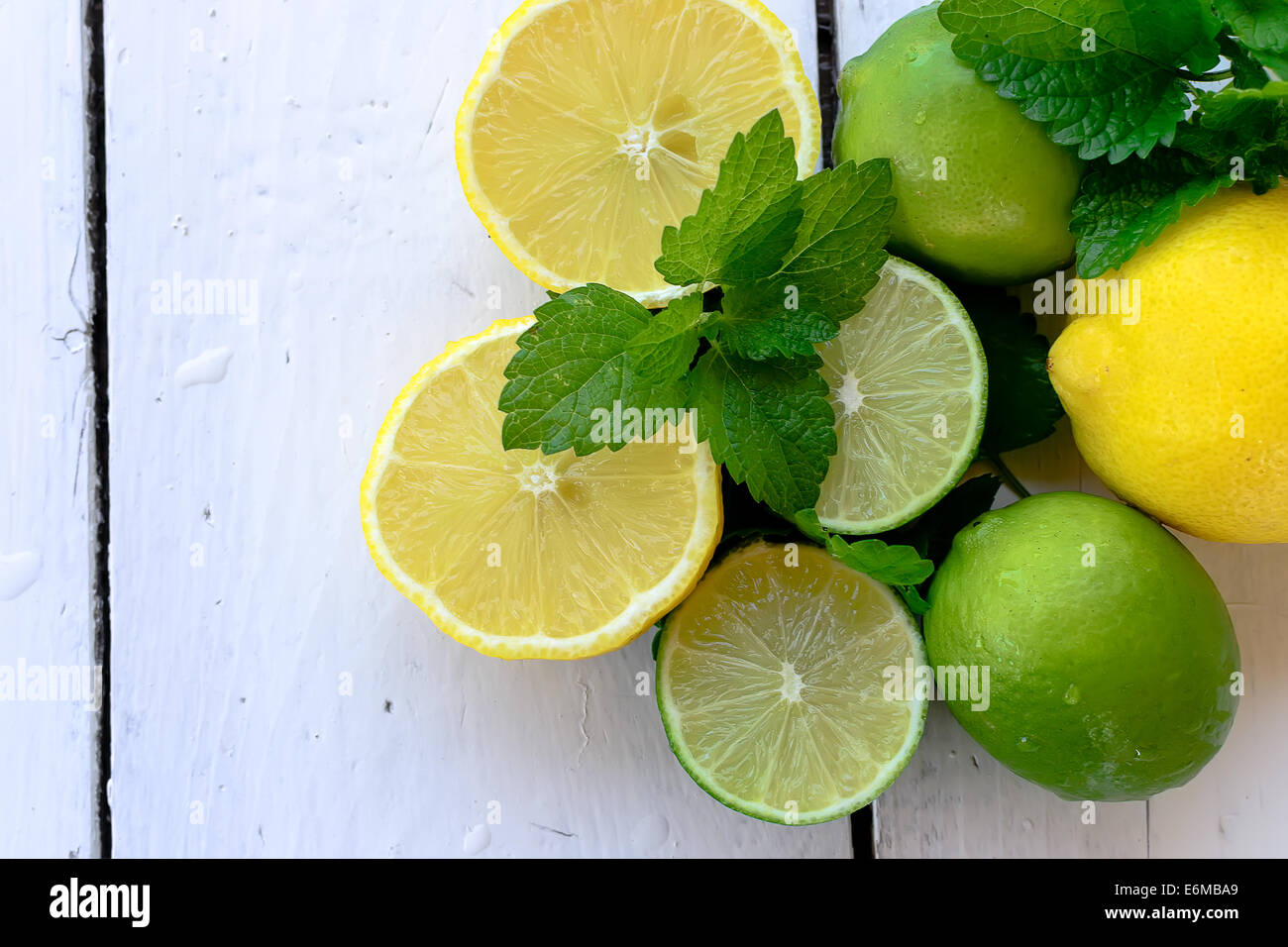 Citrus fresh fruits - lemon and lime on the white wooden table Stock ...