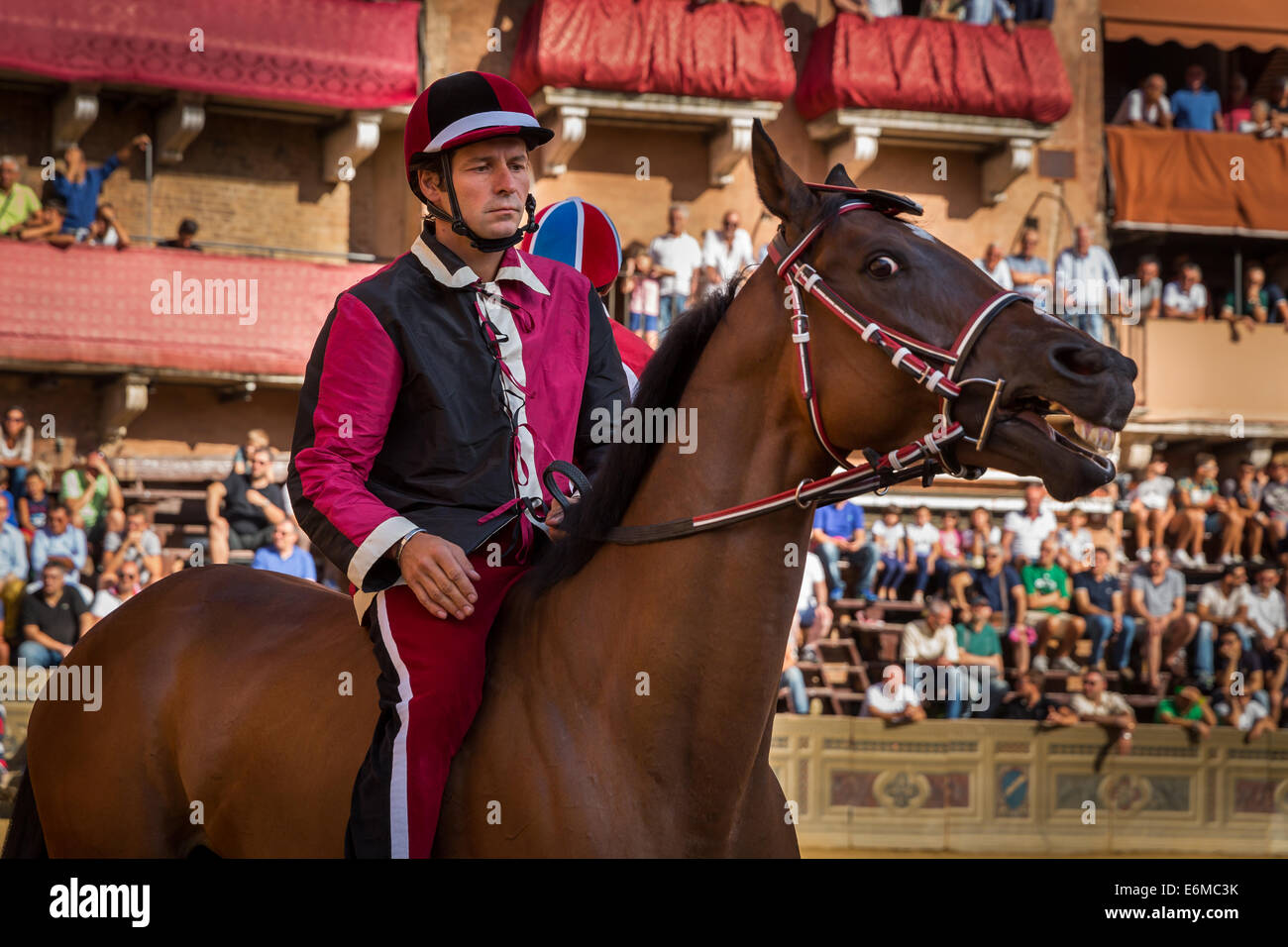A jockey waiting for the start of Palio di Siena horse race on Piazza ...