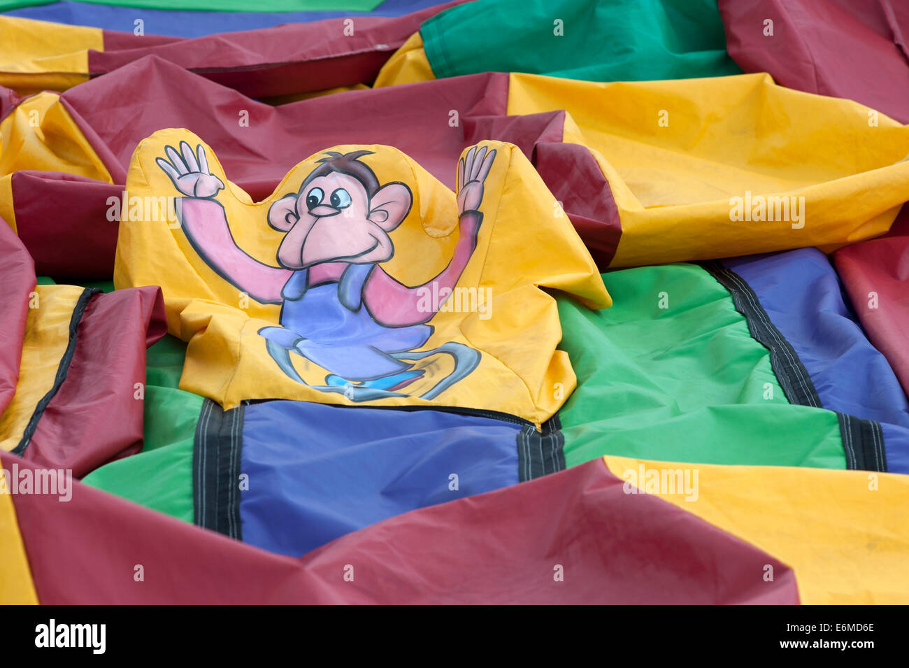 monkey design on a colourful bouncy castle awaiting inflation Stock ...