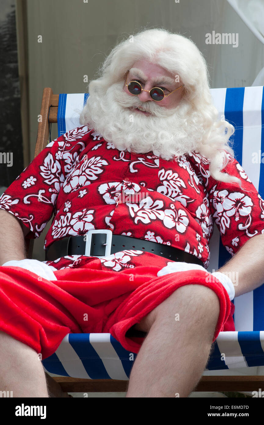 santa claus relaxing in shorts and flowery shirt as he puts in an early ...