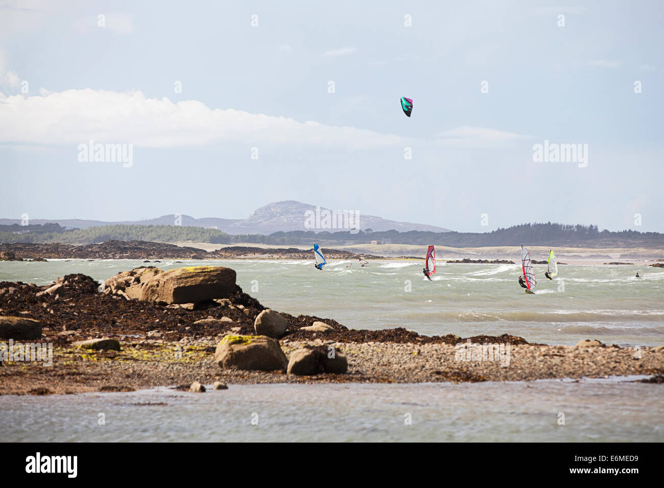 Kite surfers and wind surfers, Rhosneigr Beach, Anglesey, Valley in the ...