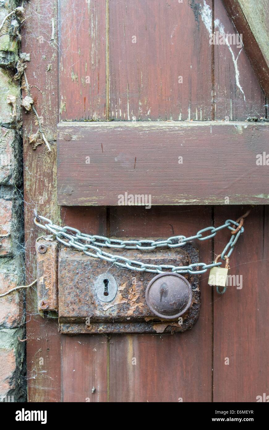 Rusty door lock with additonal chain Stock Photo - Alamy