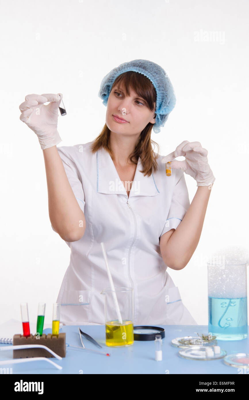 Young beautiful girl posing chemical experiments in the laboratory ...