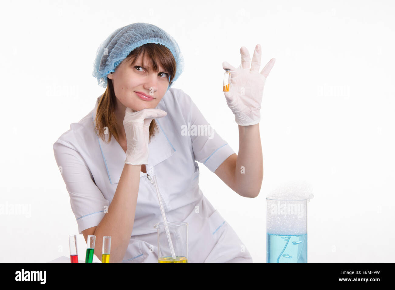 Young beautiful girl posing chemical experiments in the laboratory ...