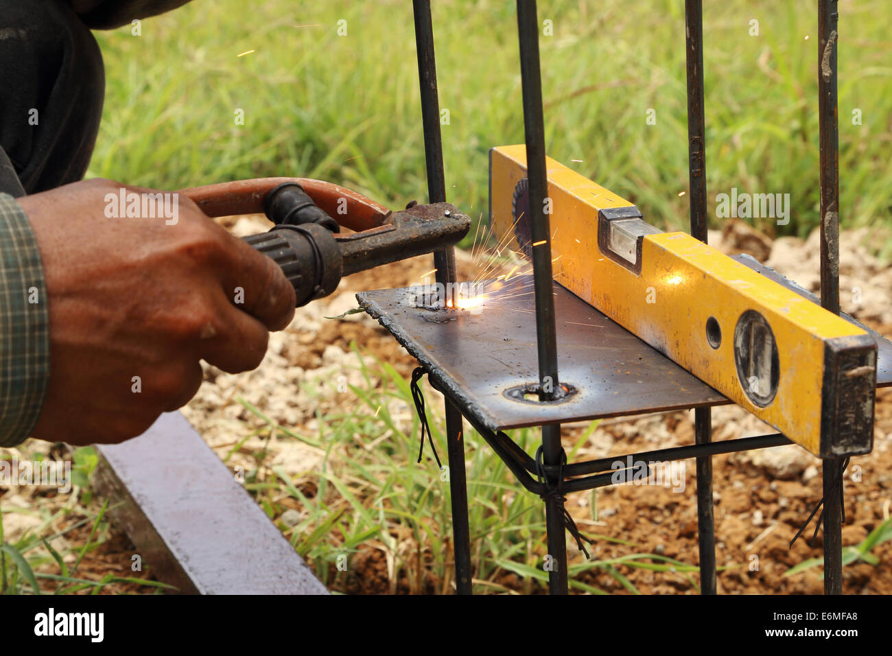 electric welding connecting metal rod and metal plate with level meter ...