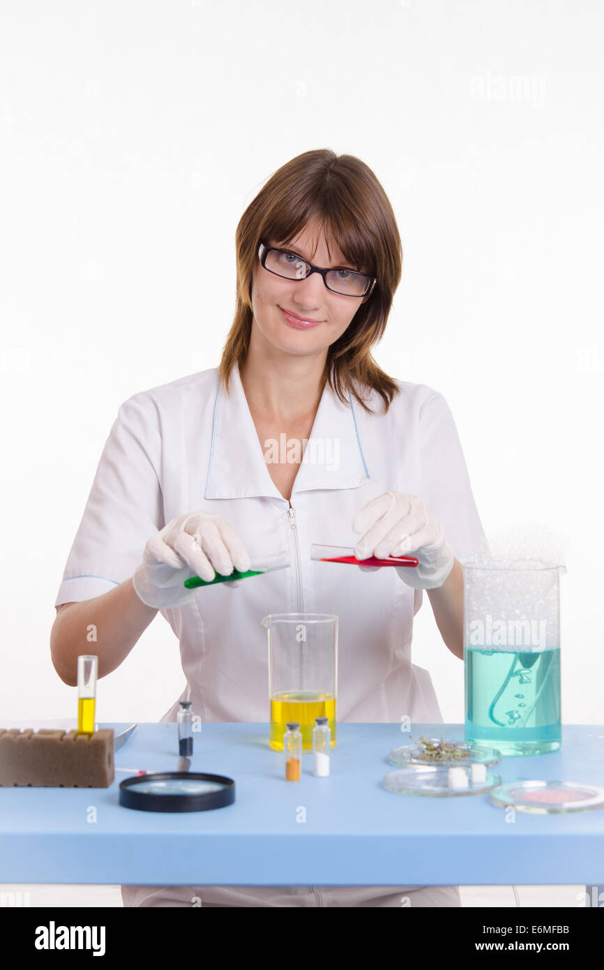 Young beautiful girl posing chemical experiments in the laboratory ...
