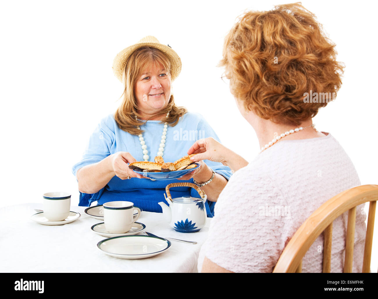 Two Mature Ladies Enjoying A Tea Party Together White Background Stock