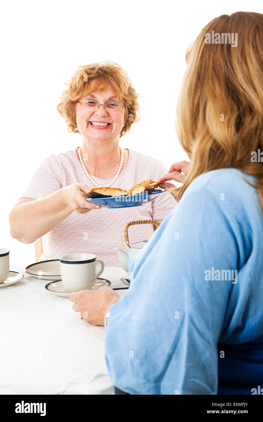 Two mature ladies having a tea party together. White background Stock ...