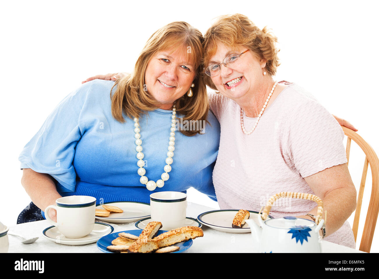 Two middle-aged best friends having a tea party together. White ...