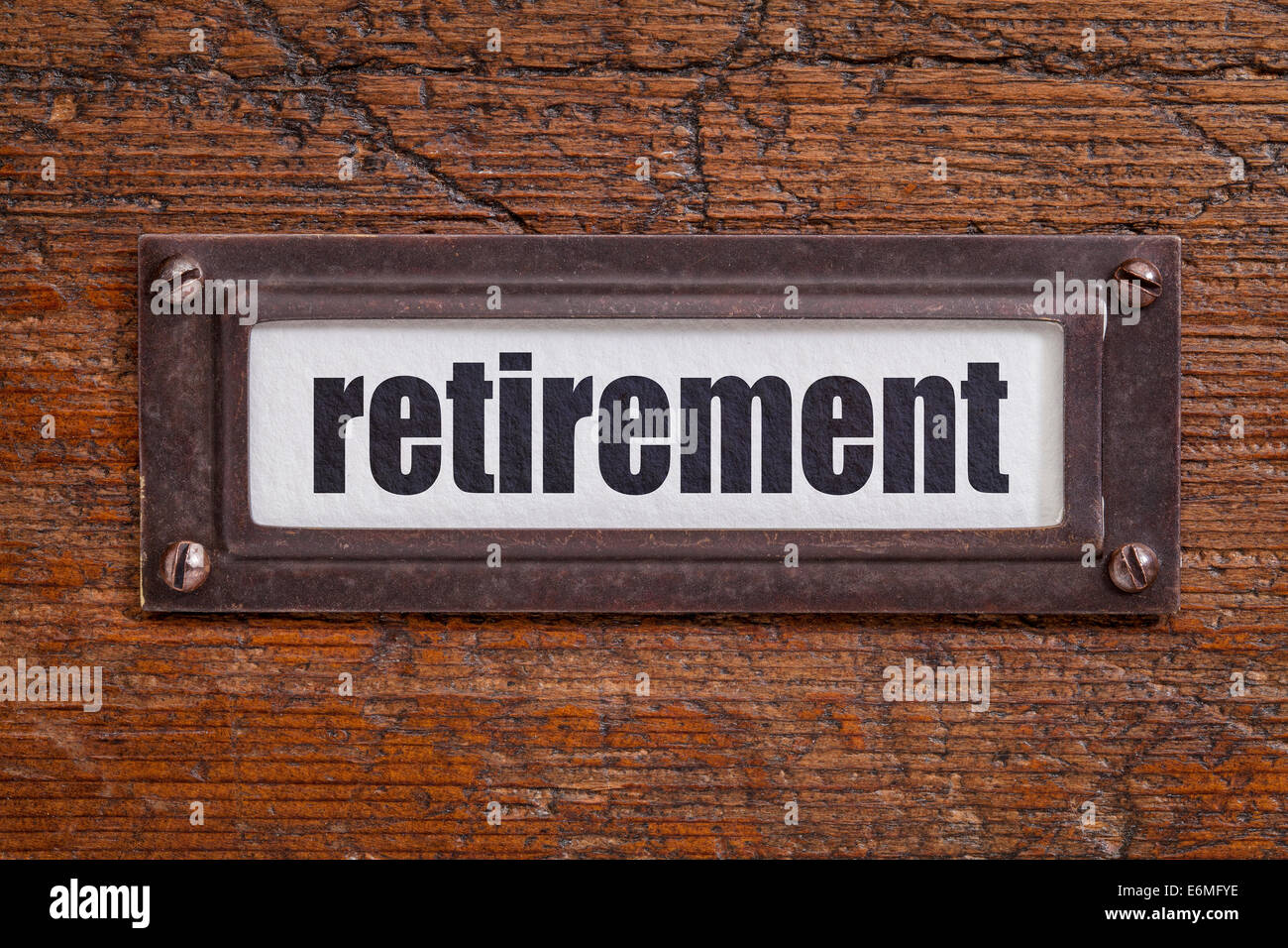retirement word - file cabinet label, bronze holder against grunge and ...