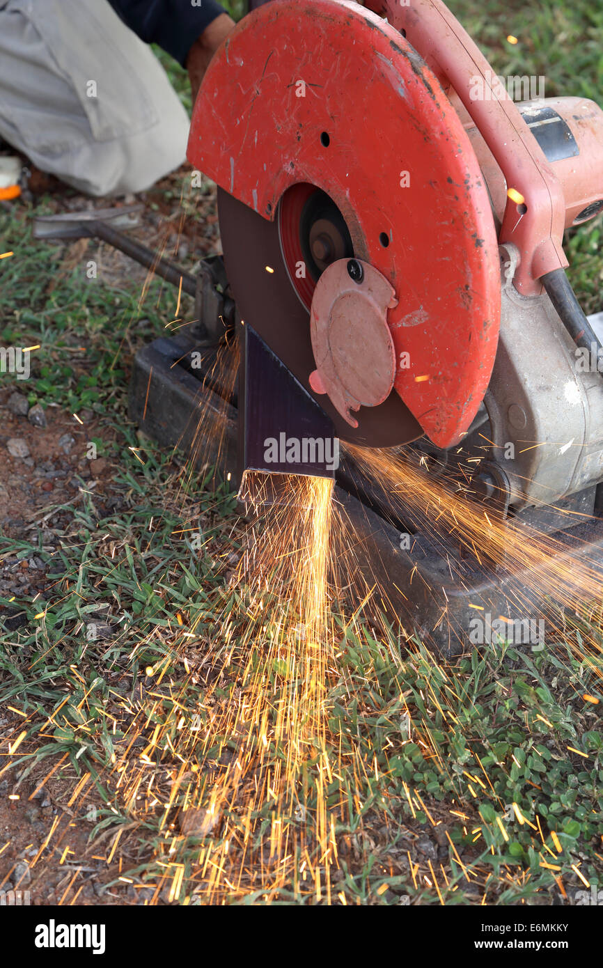 Worker cutting metal and spark with cutting machine Stock Photo - Alamy