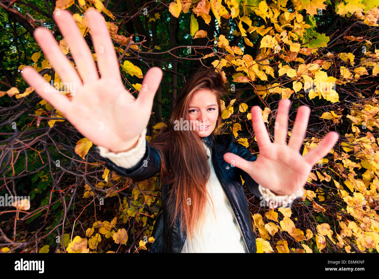 Fall season. Portrait of happy girl young woman lying on the colorful ...