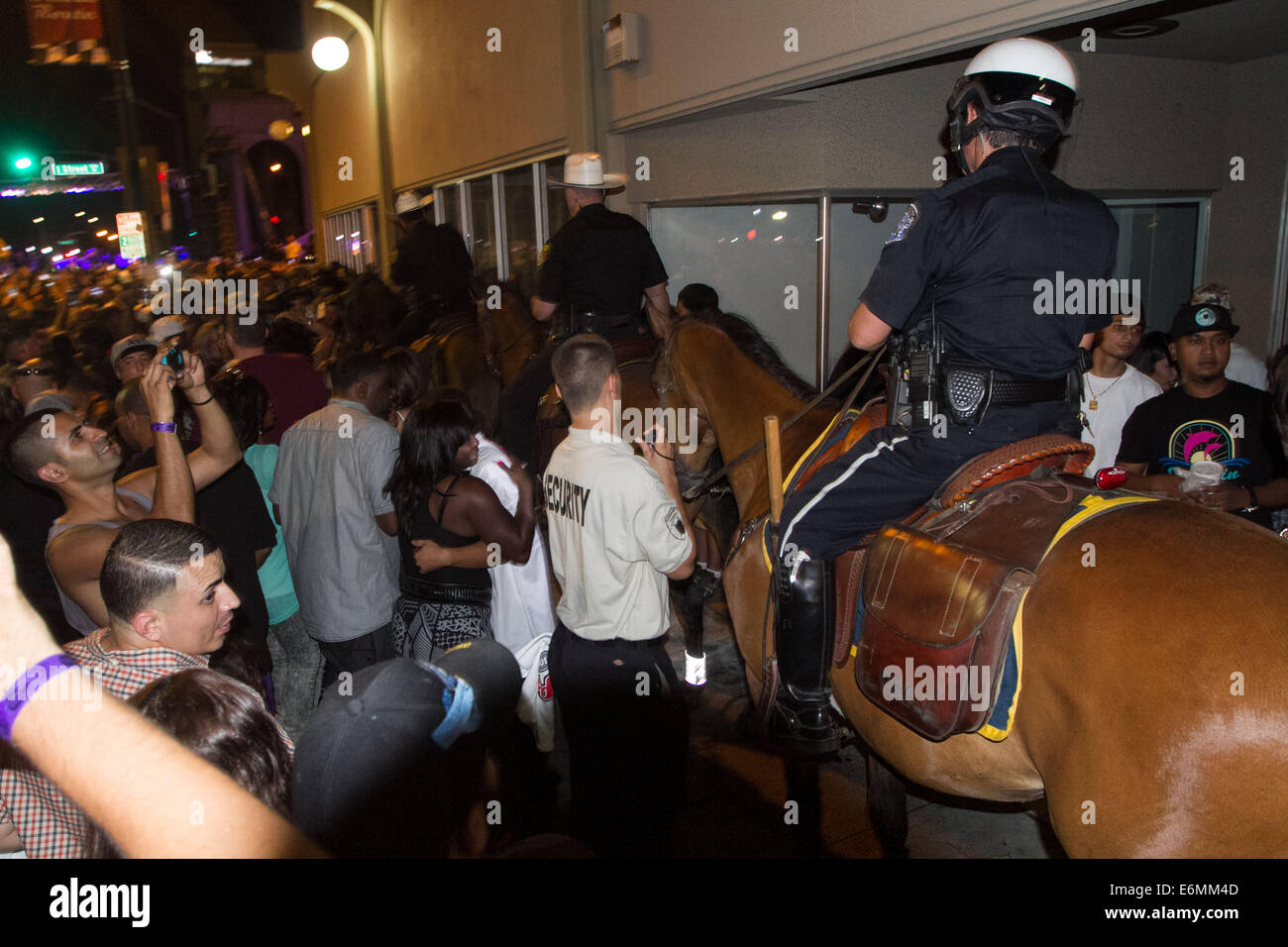 Modesto, CA, USA. 23rd Aug, 2014. Mounted Police walk through the crowd ...