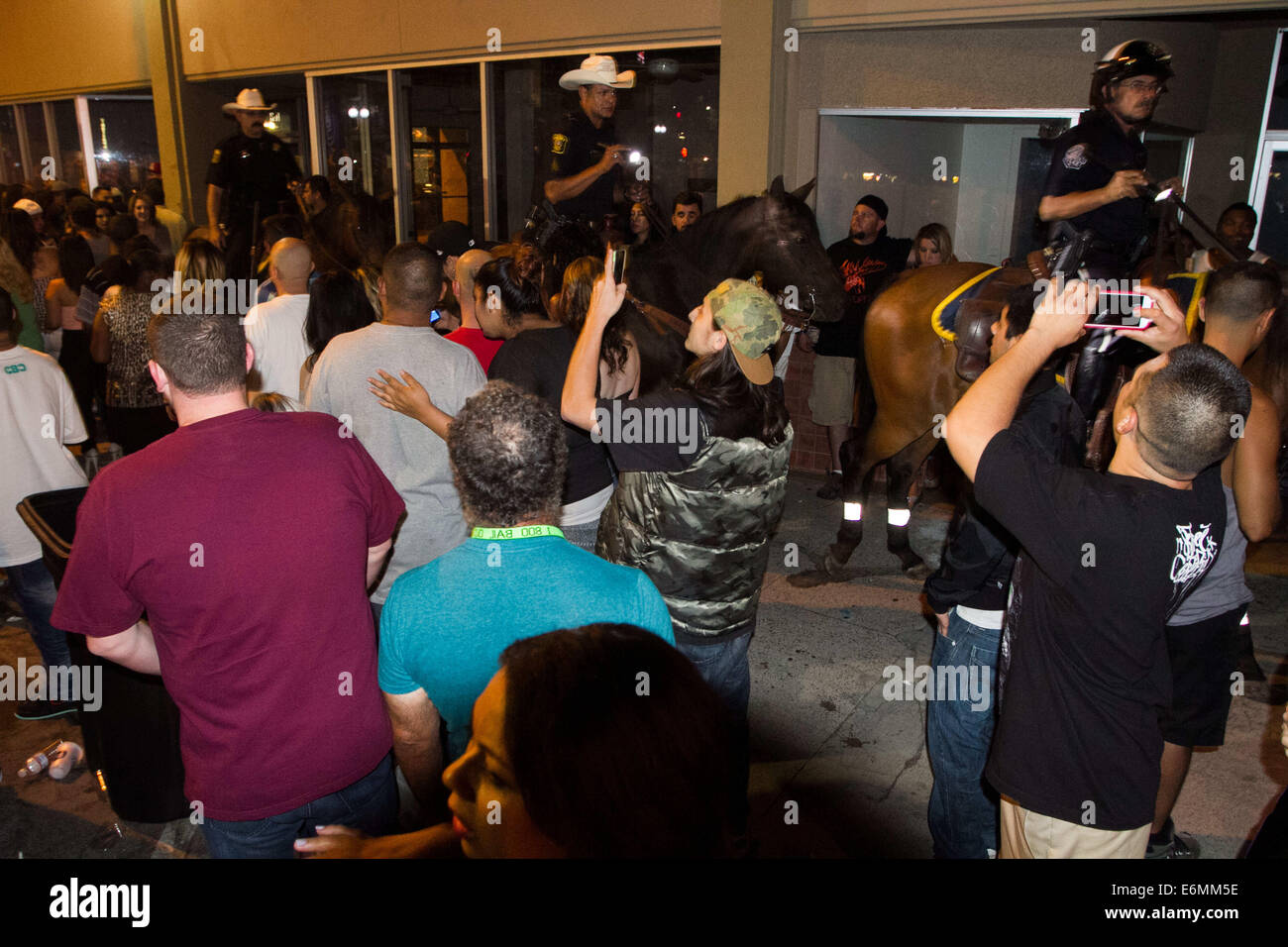 Modesto, CA, USA. 23rd Aug, 2014. Mounted Police walk through the crowd ...