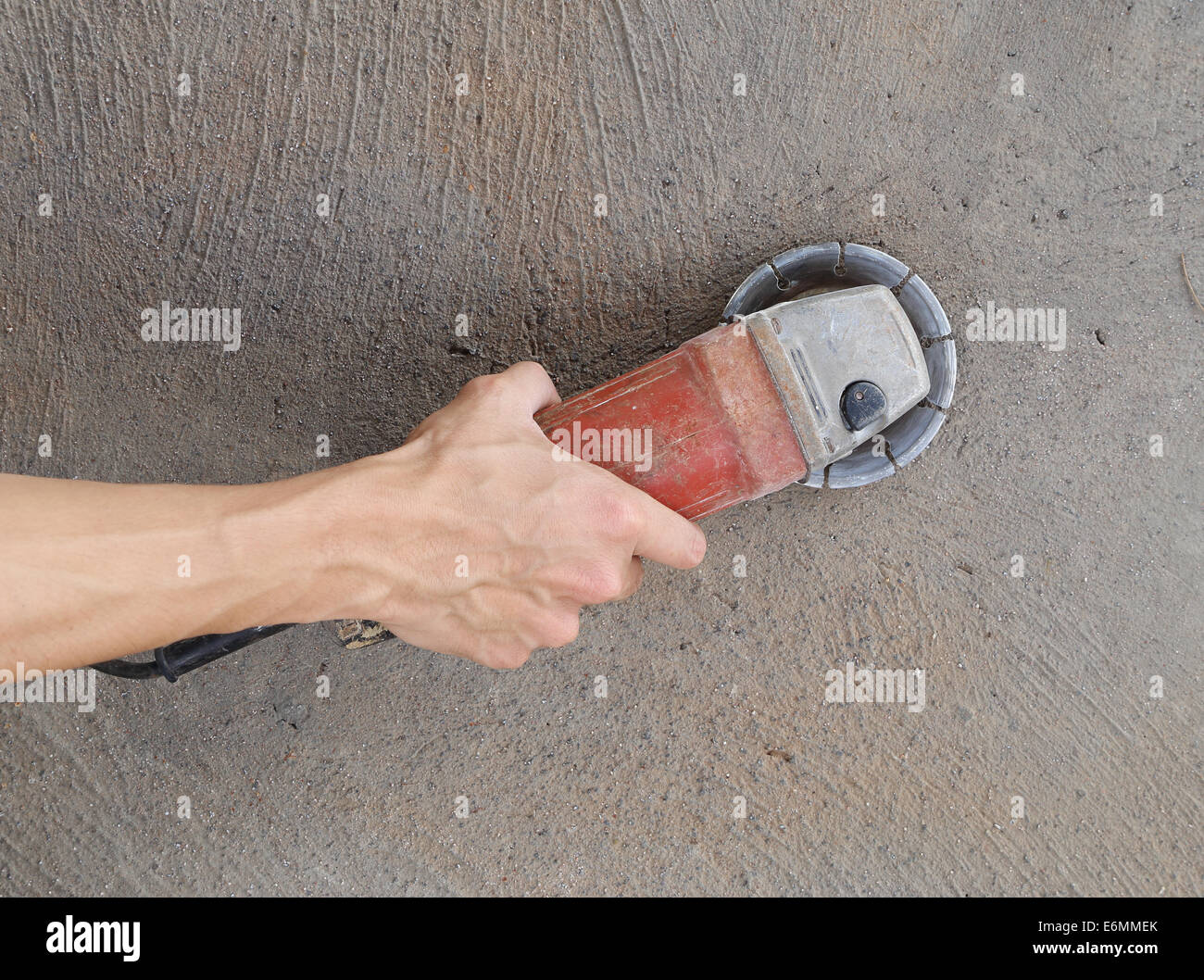 hand with grinding tool on concrete background Stock Photo - Alamy
