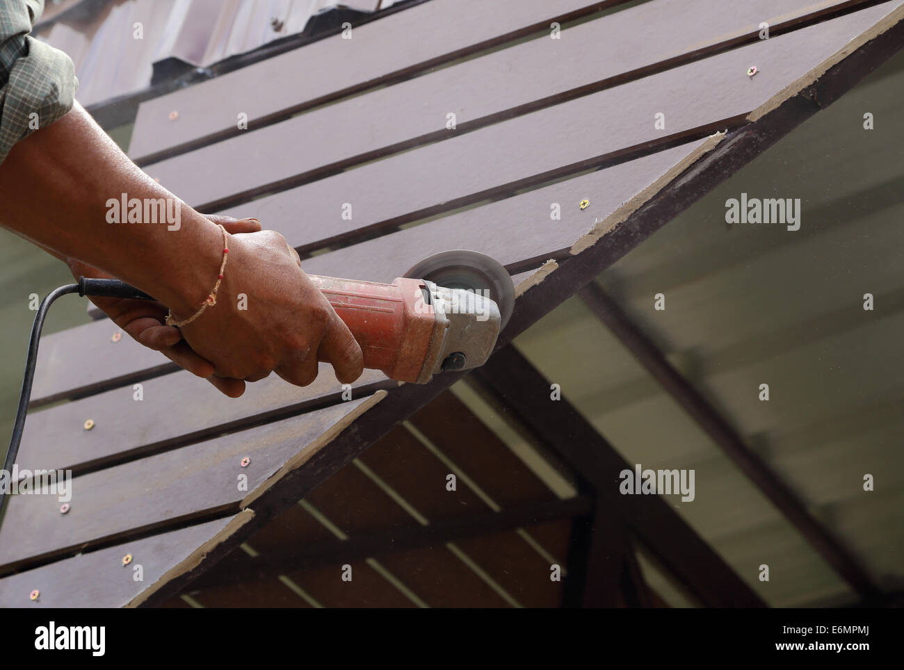 worker use small grinding tool for cutting wood construction Stock ...
