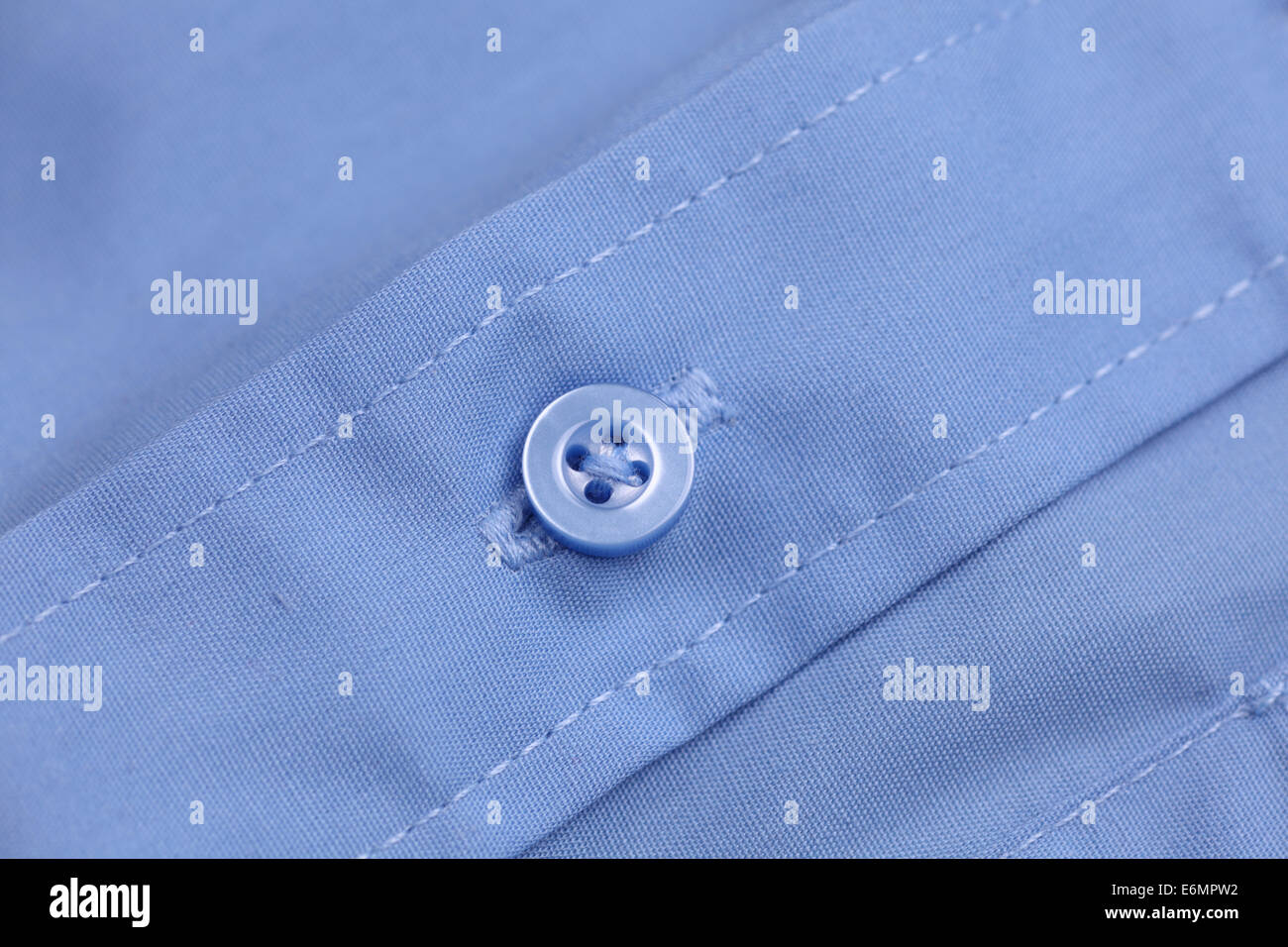 Closeup of blue button on a blue shirt Stock Photo - Alamy