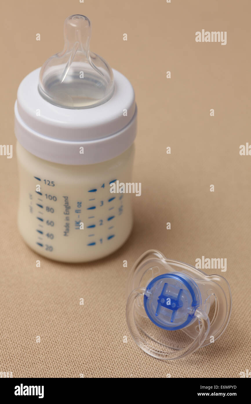 Baby bottle with milk and pacifier Stock Photo - Alamy