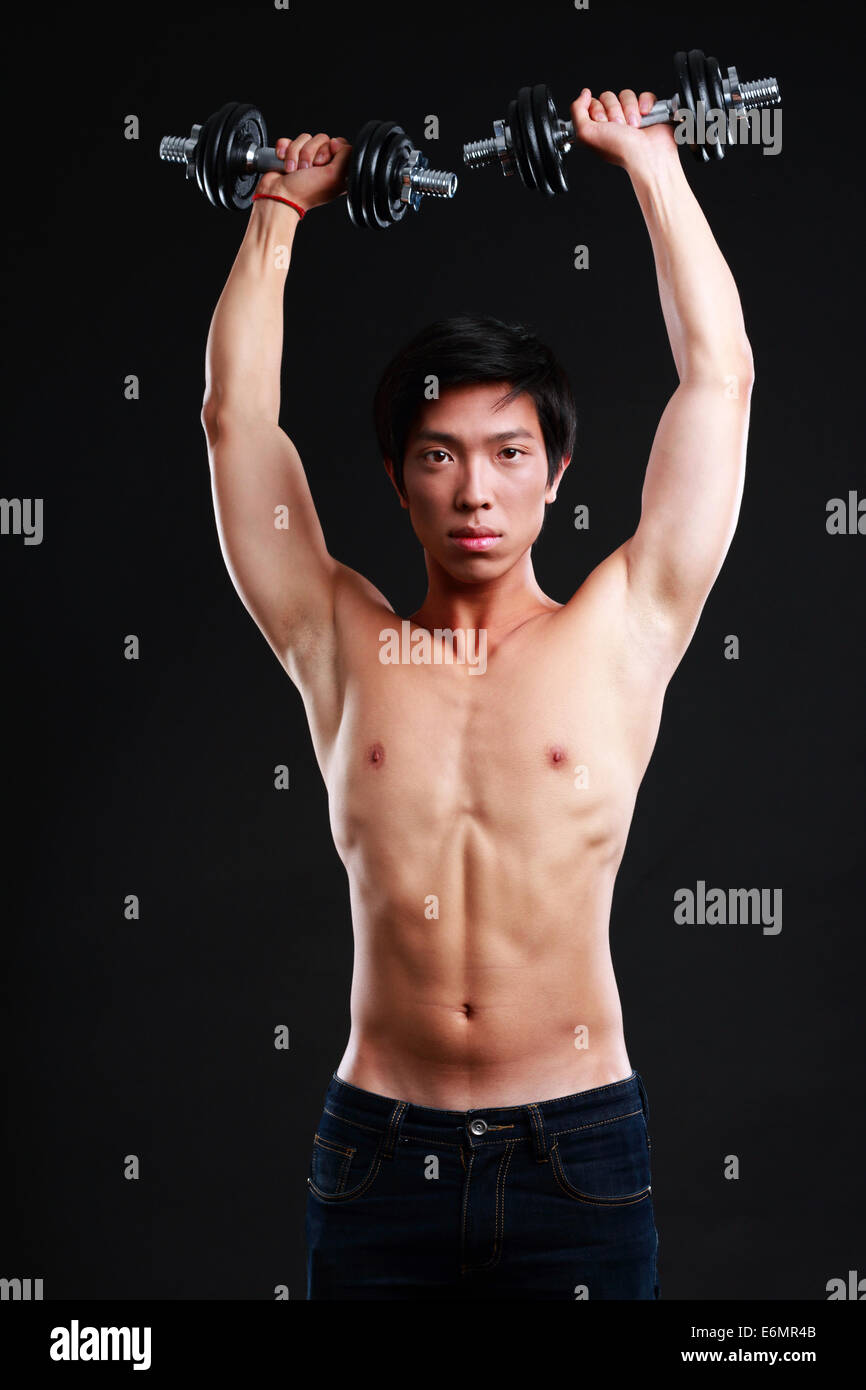 Asian man working out with dumbbells on black background Stock Photo ...