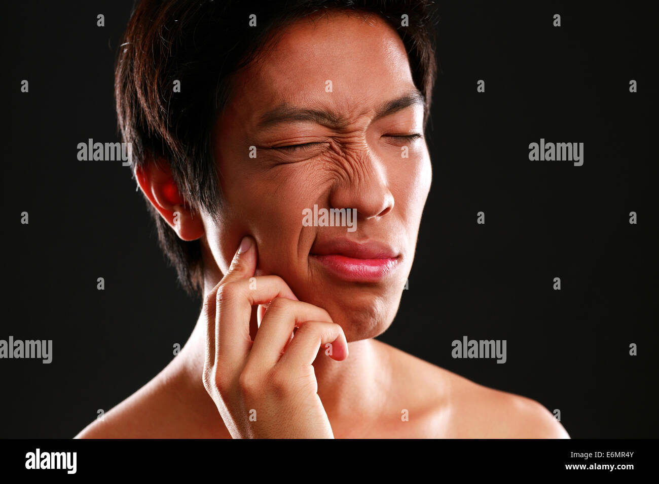 Portrait of a young Asian man with toothache Stock Photo - Alamy