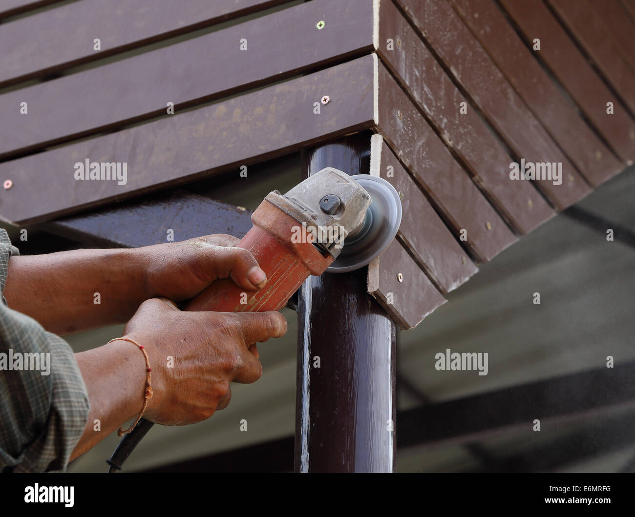 worker use small grinding tool for cutting wood construction Stock ...