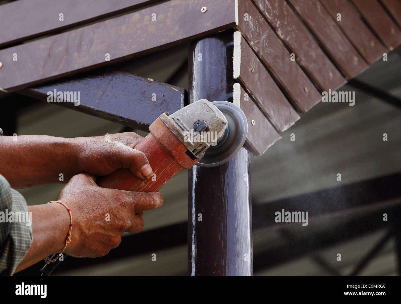 worker use small grinding tool for cutting wood construction Stock ...